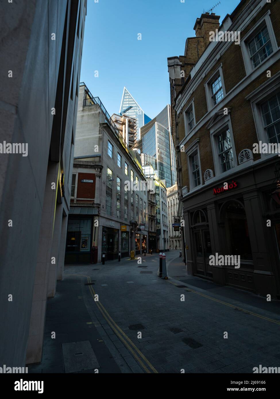 Side street in the city with high rise business towers in the ...