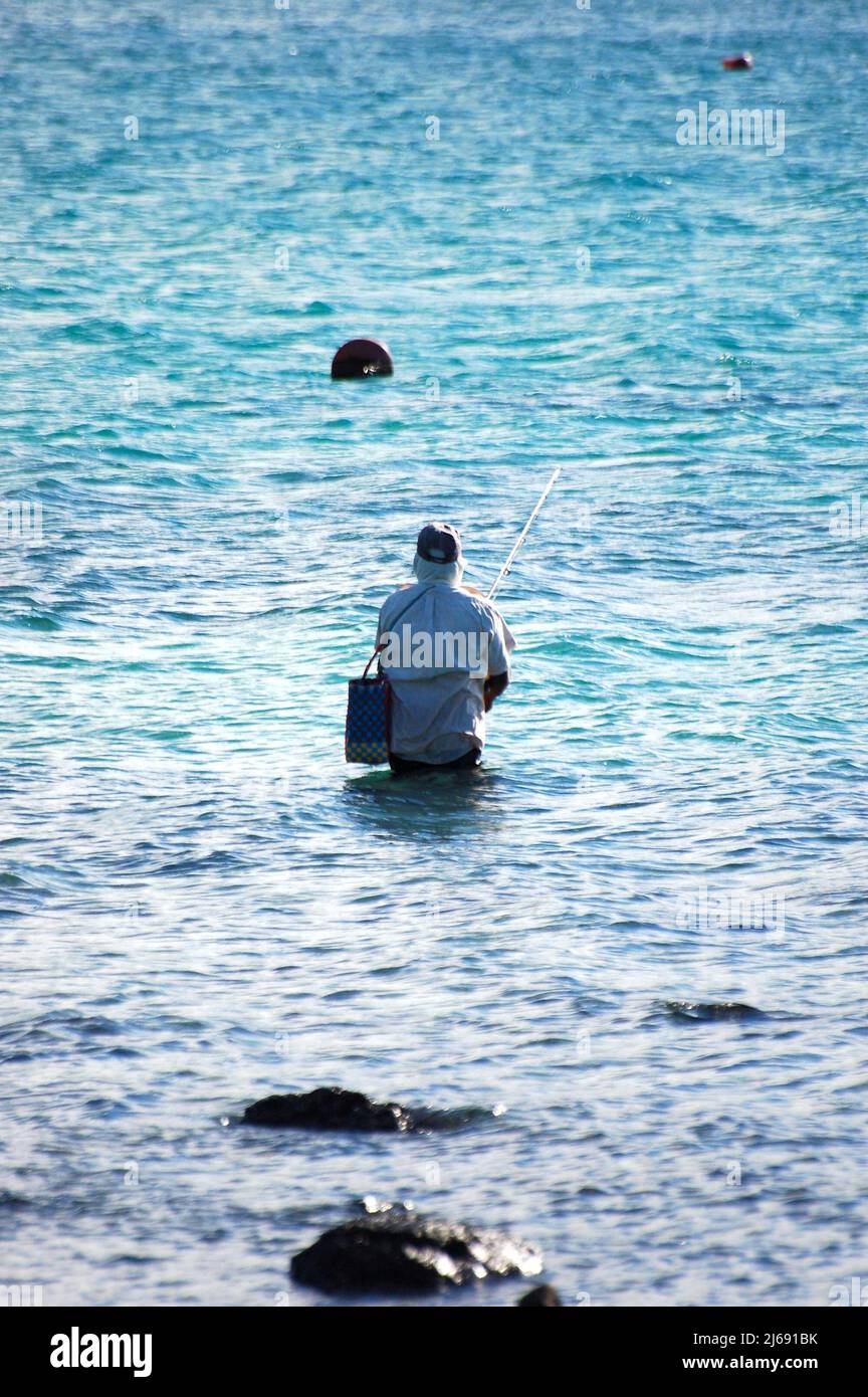 fisherman catches fish on the ocean Stock Photo - Alamy