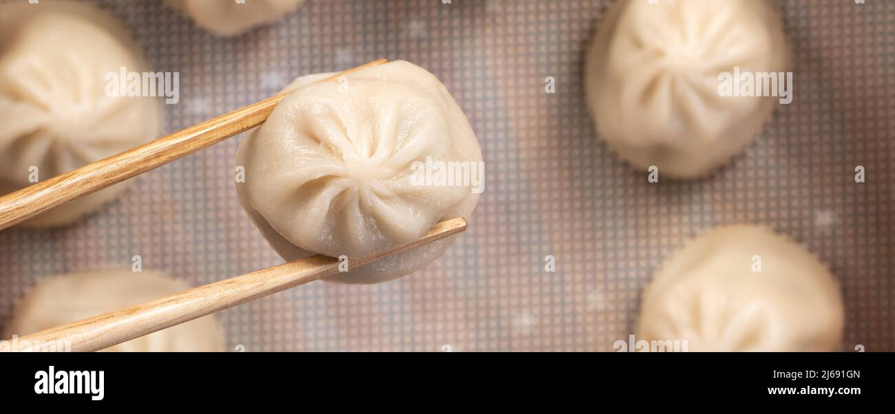 Eating steamed pork soup dumplings named Xiao long bao xiaolongbao in ...