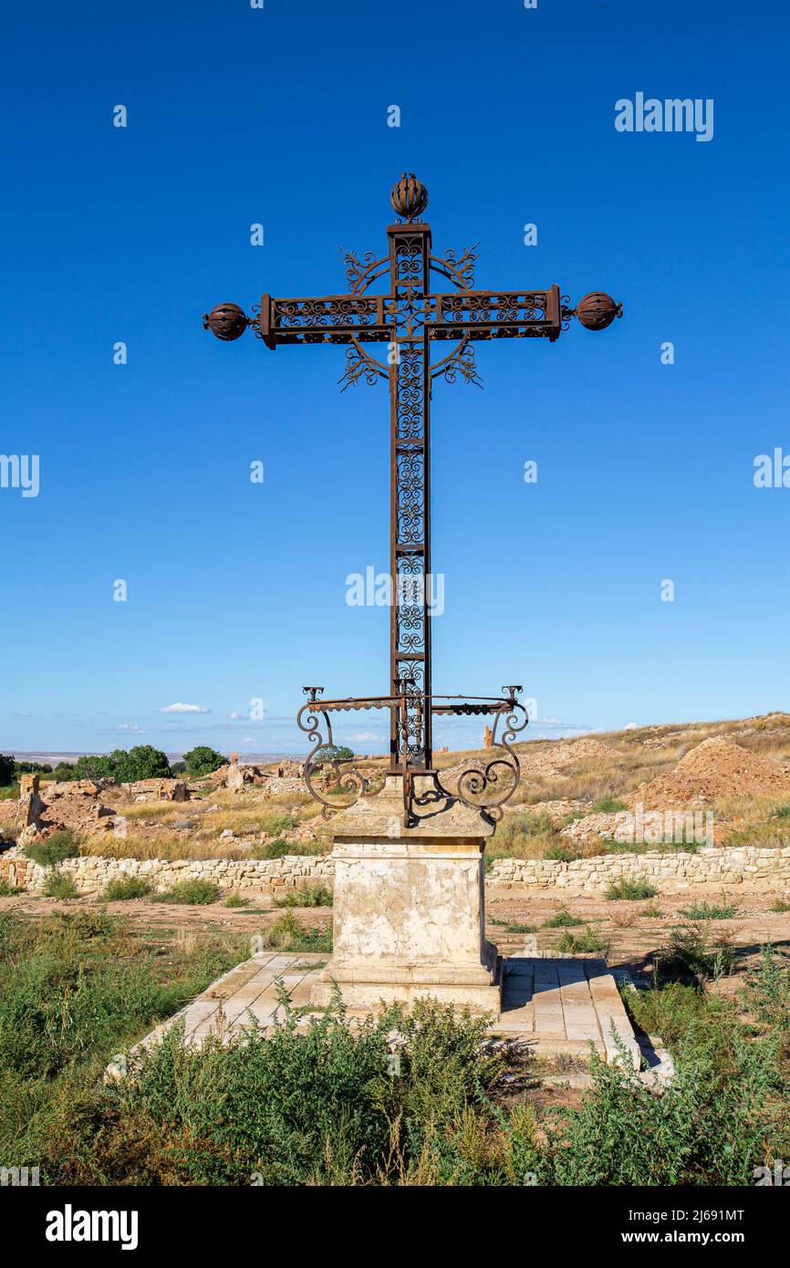 Ancient wrought iron cross on a temple in the old town of Belchite in ...