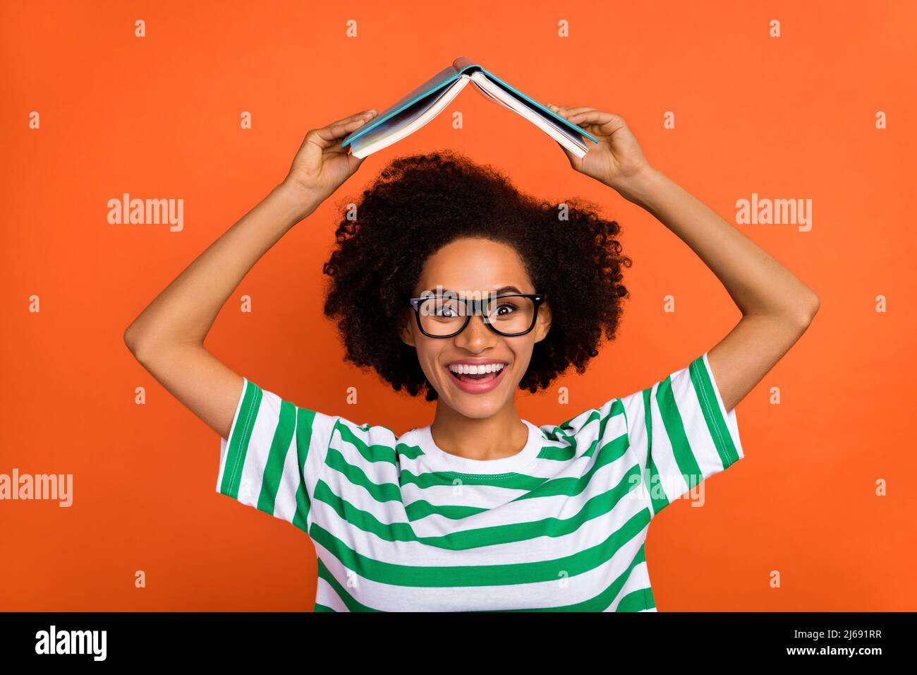 Portrait of attractive cheerful brainy wavy-haired girl holding book ...