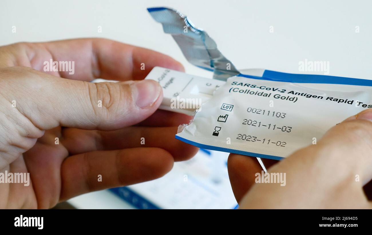 Man hands open sterile package with coronavirus antigen test for self ...