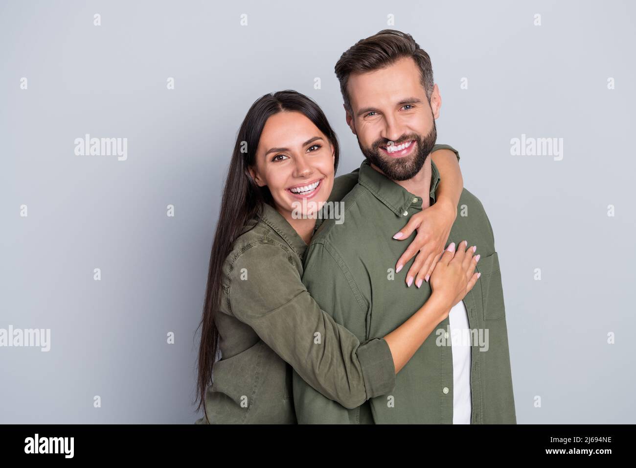 Portrait of attractive cheerful amorous couple best friends hugging ...