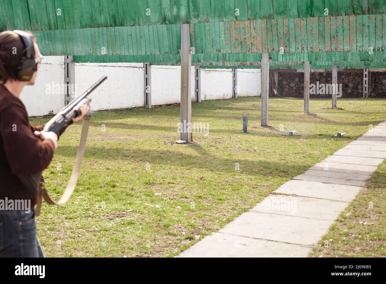 A young man shoots at metal flags, targets. Firearms pump-action ...