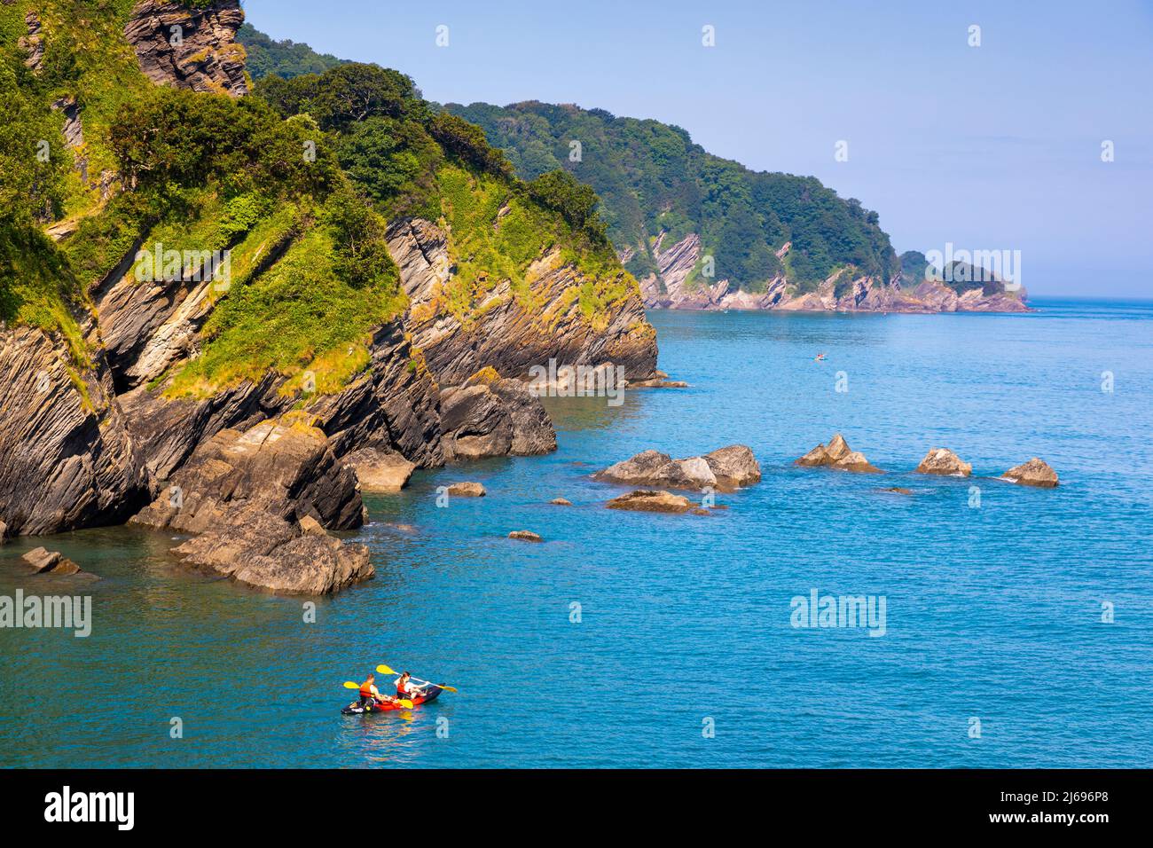 Kayakers and coastal view, Combe Martin, Exmoor National Park, North ...