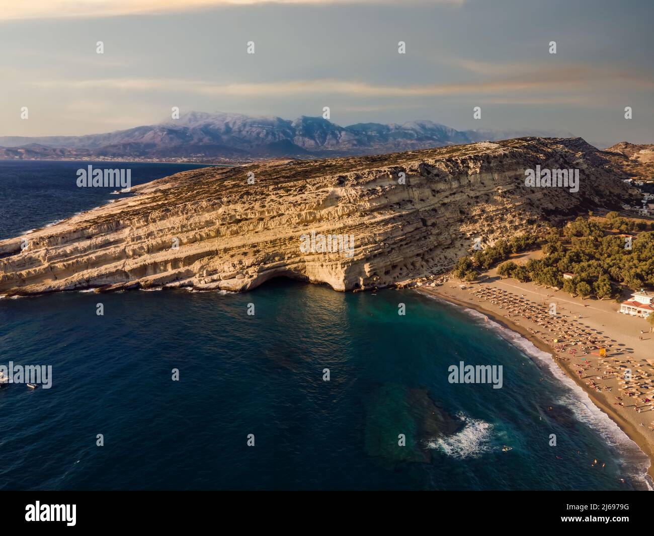 Drone view of Matala artificial caves on the rock by the beach at Crete ...