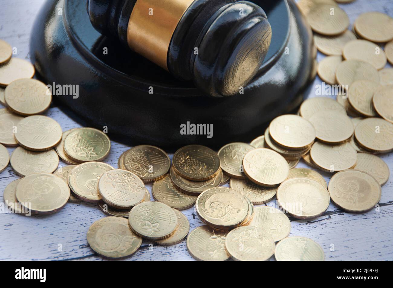 Lawyer gavel on wooden table with gold coins. Law concept Stock Photo ...