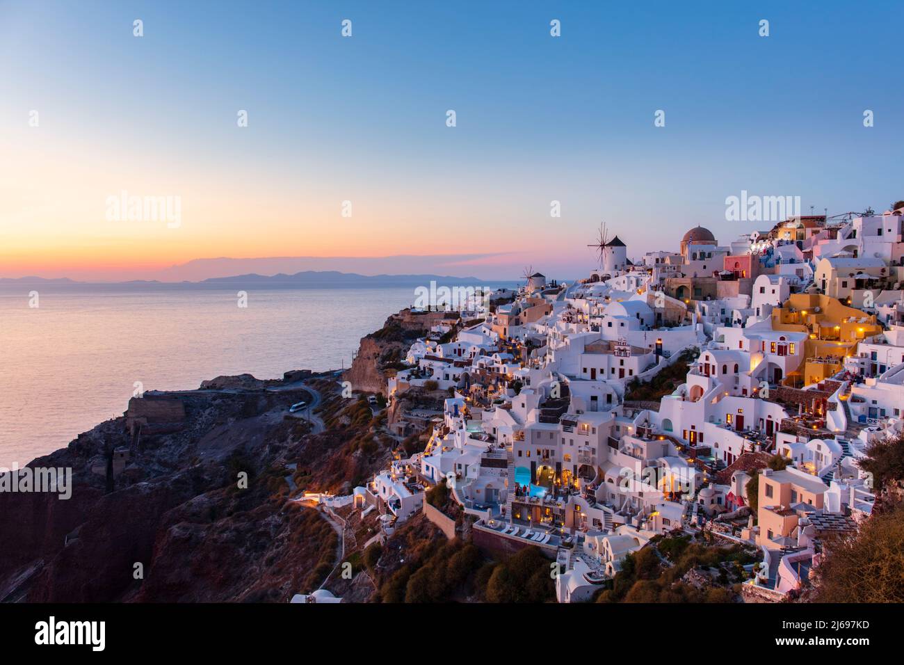Sunset view of buildings overlooking sea, Oia, Santorini, Cyclades ...