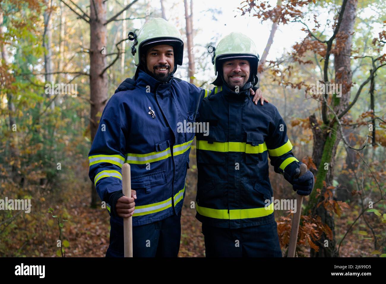 Happy firefighters men after action, stopping fire in forest and ...