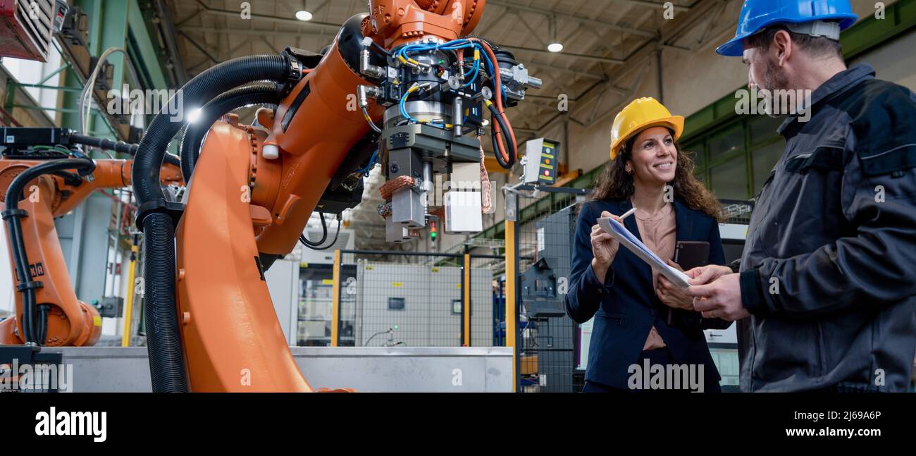 Female engineering manager and mechanic worker doing routine check up ...