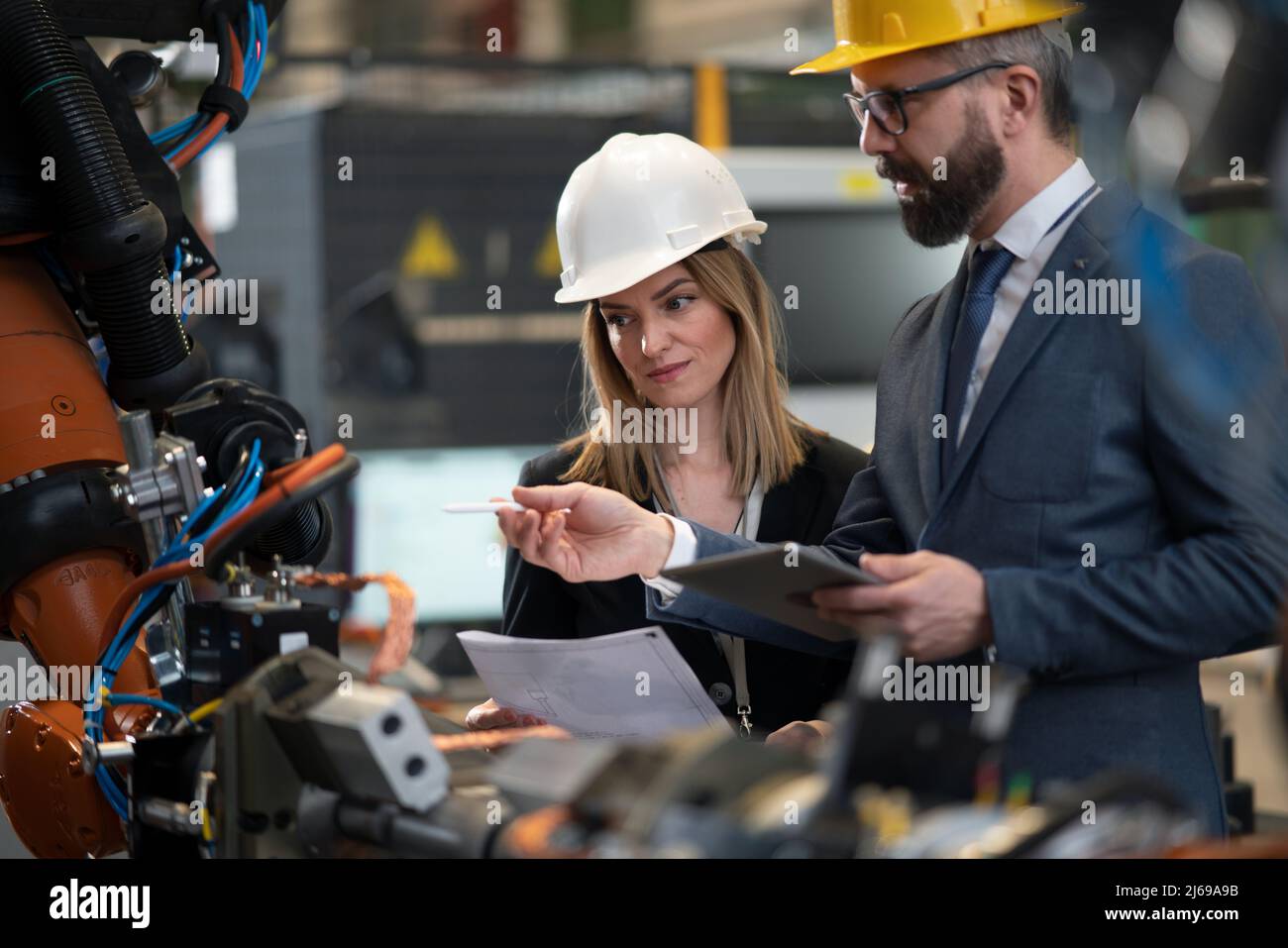Chief engineer and project manager in modern industrial factory with ...