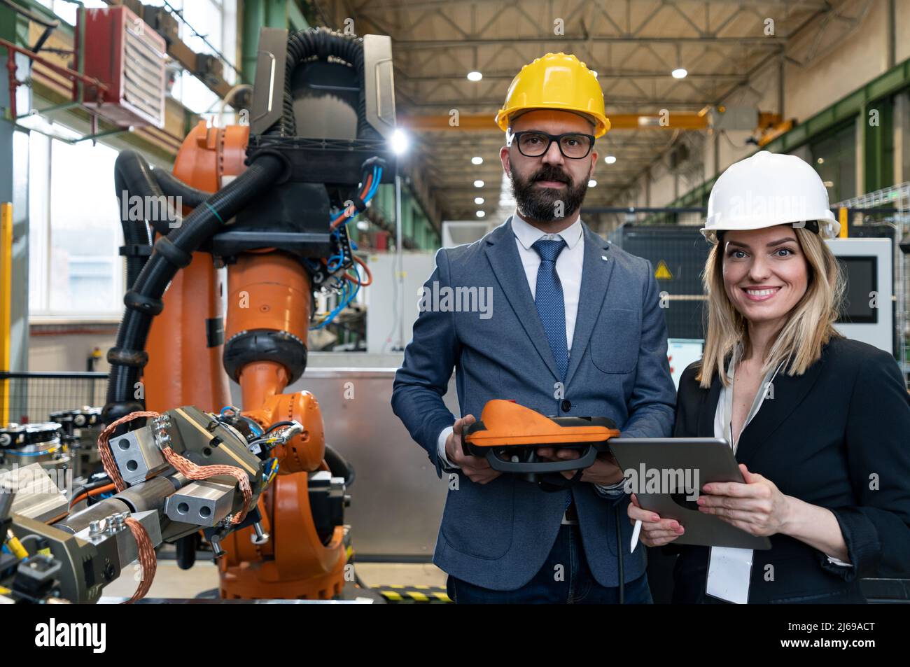 Chief engineer and project manager in modern industrial factory with ...