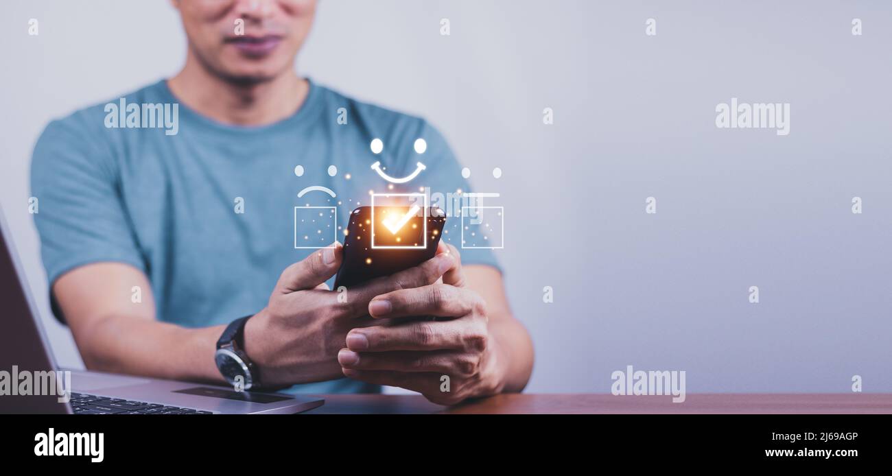 Customer service evaluation concept. smiling Asian male Is using a ...