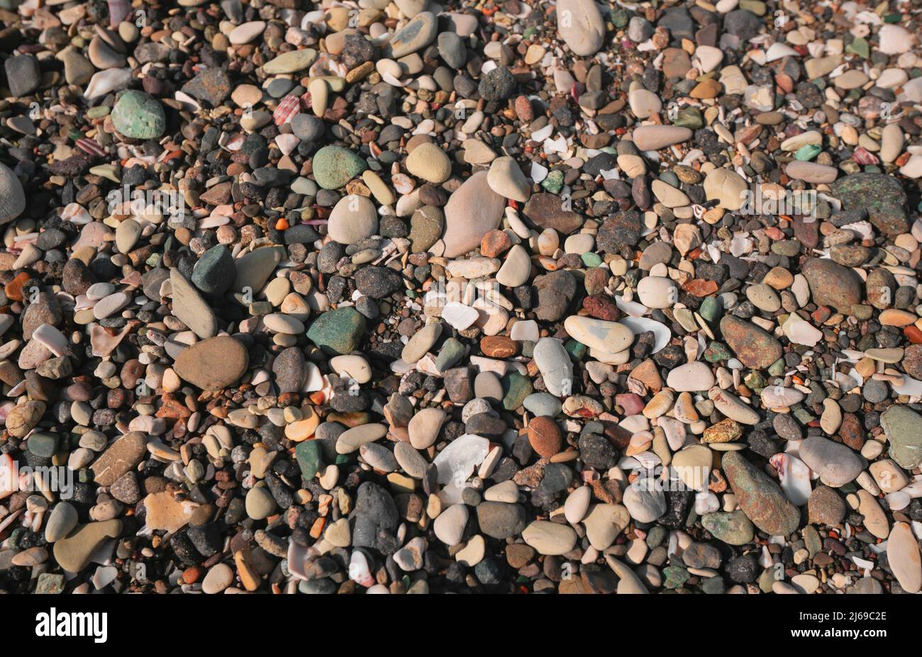 Approach to a large group of stones and pieces of shell scattered on ...