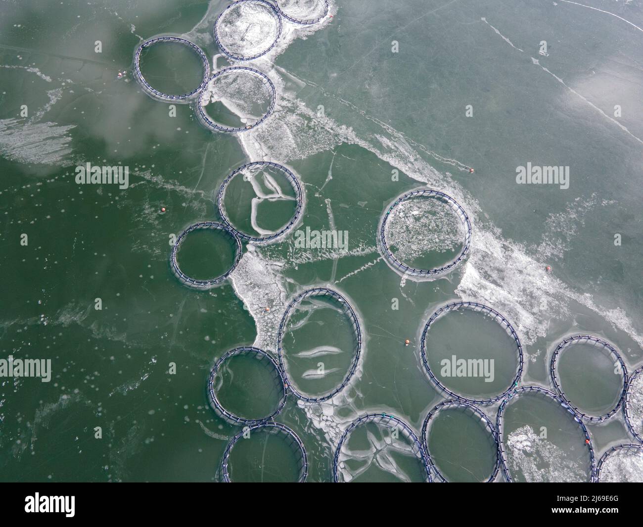 Aerial winter view of Dospat Reservoir covered with ice, Smolyan Region ...