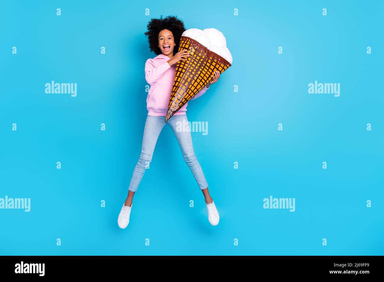 Full size photo of young girl have fun jump energetic holding big ice ...