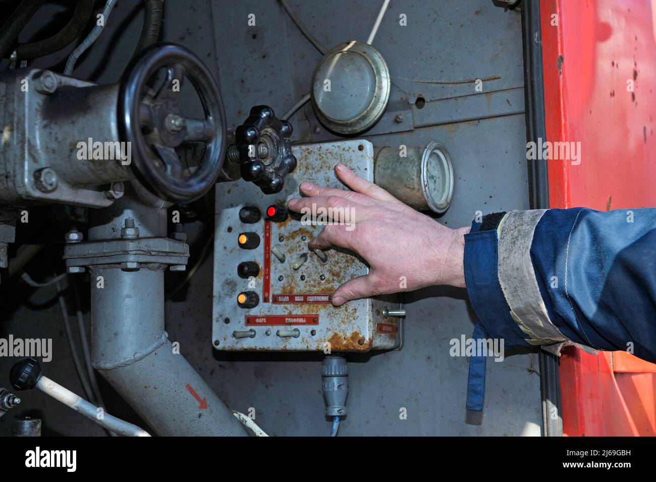 Fireman switching the water pump engine on control panel Stock Photo ...