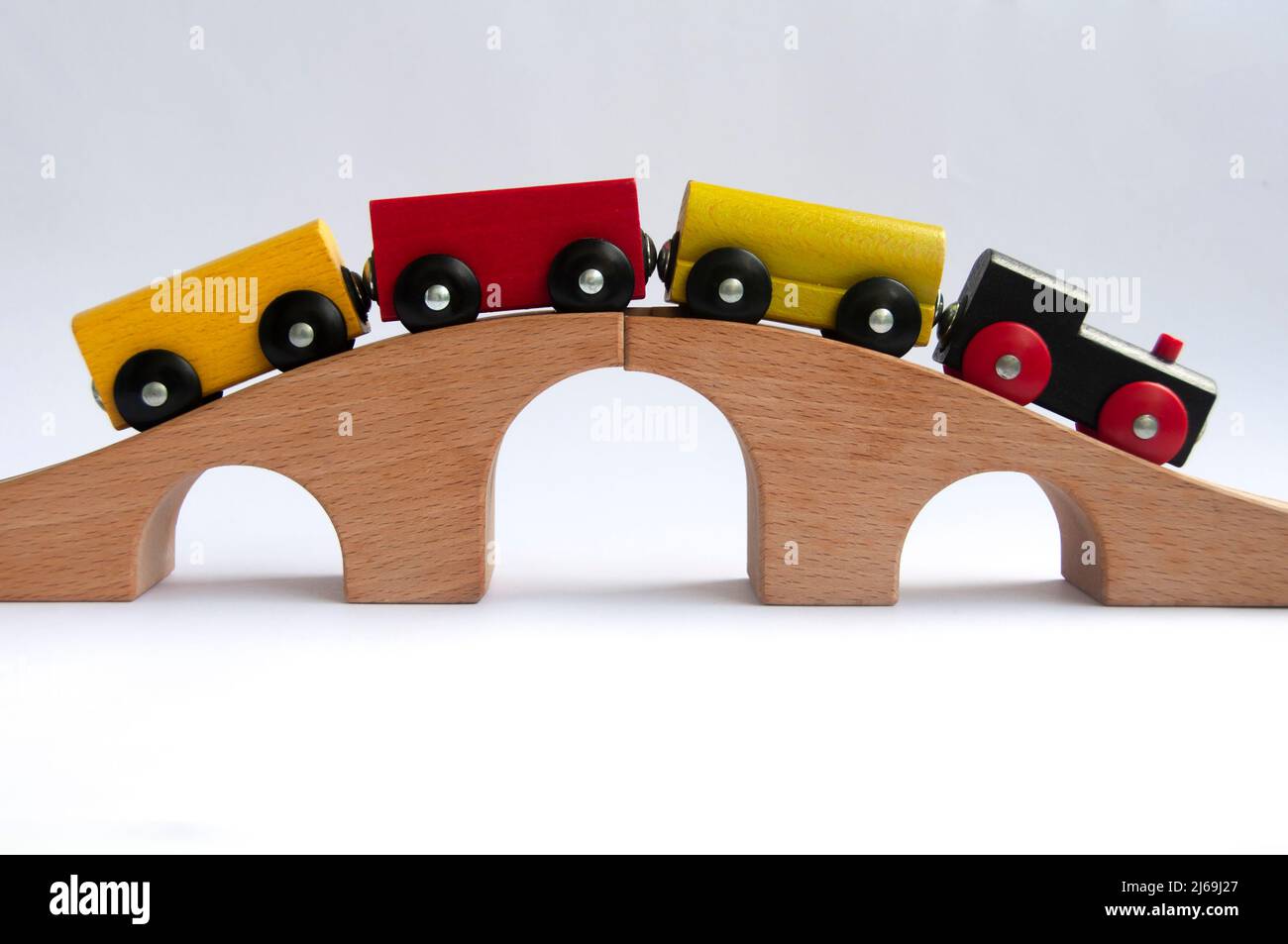 Wooden toy train crossing track bridge. Conceptual Stock Photo - Alamy
