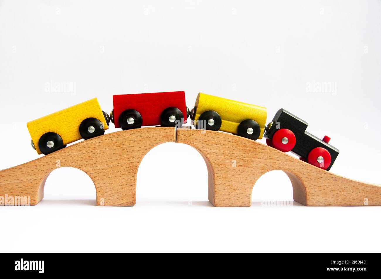 Wooden toy train crossing track bridge. Conceptual Stock Photo - Alamy