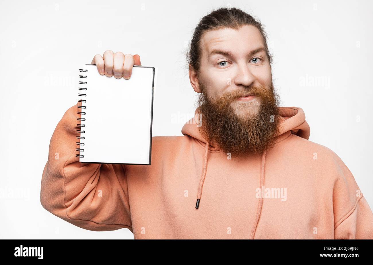 Scandinavian handsome happy man holding notepad with a white paper ...
