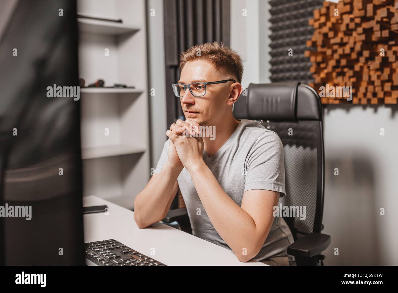 Man working in music studio using computer wearing glasses. Sound ...