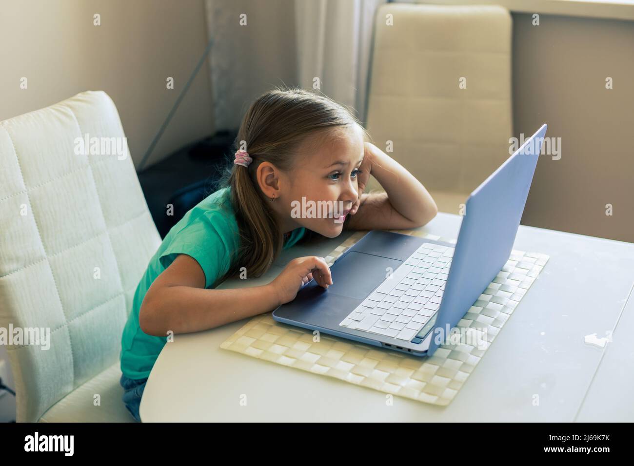 Little cute girl uses laptop to have video call Stock Photo - Alamy