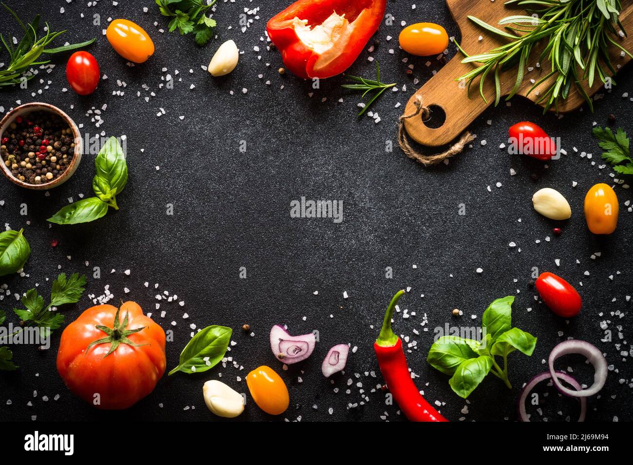 Food cooking background on black stone table Stock Photo - Alamy