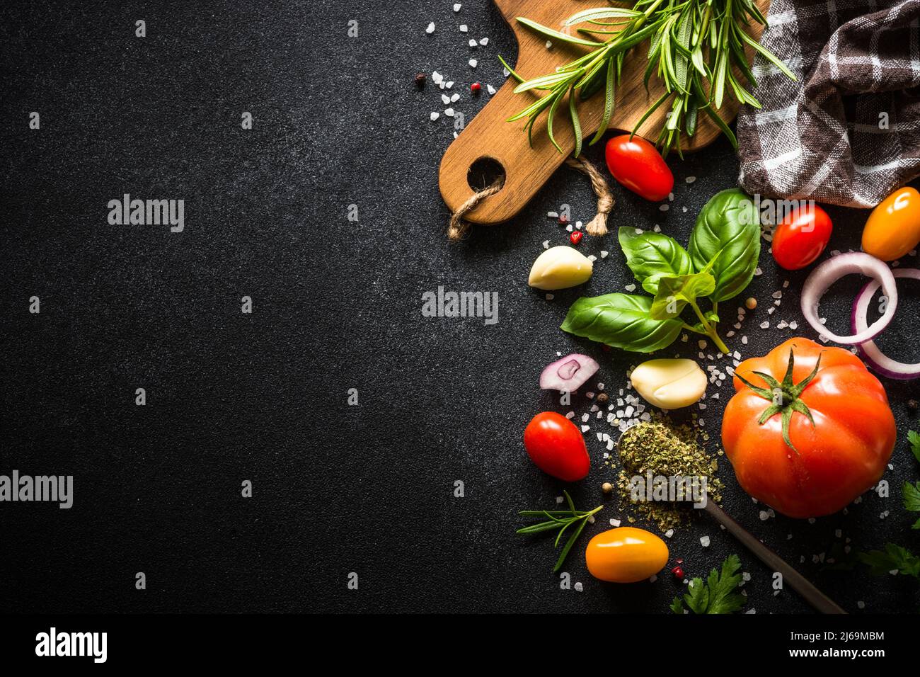Food cooking background on black stone table Stock Photo - Alamy