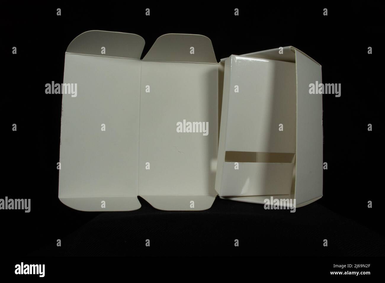 open white box with closing tabs and with insert packaging isolated on ...