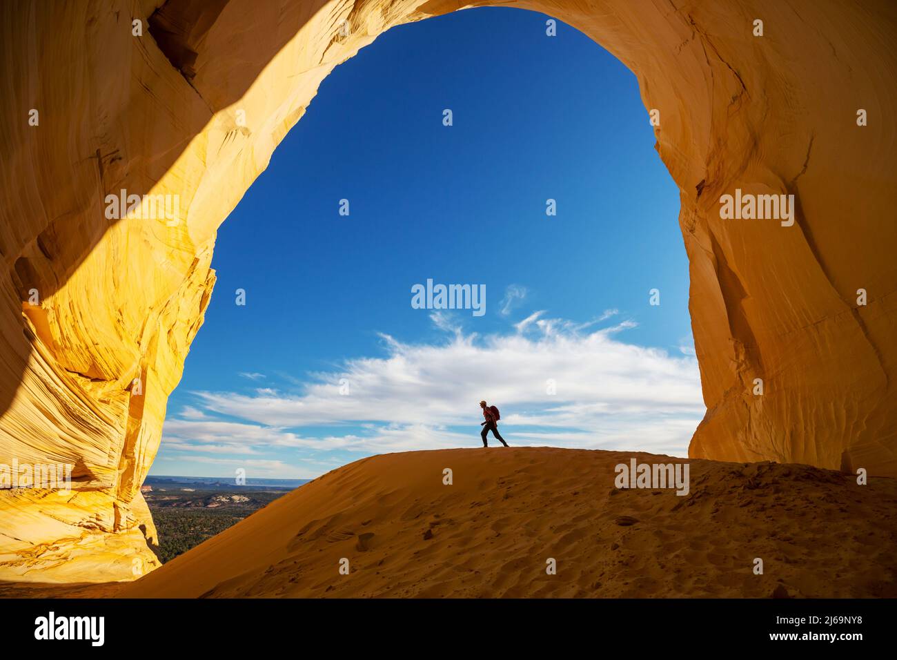 Hiker in the Great Chamber grotto, Utah, USA. Travel and journey scene ...