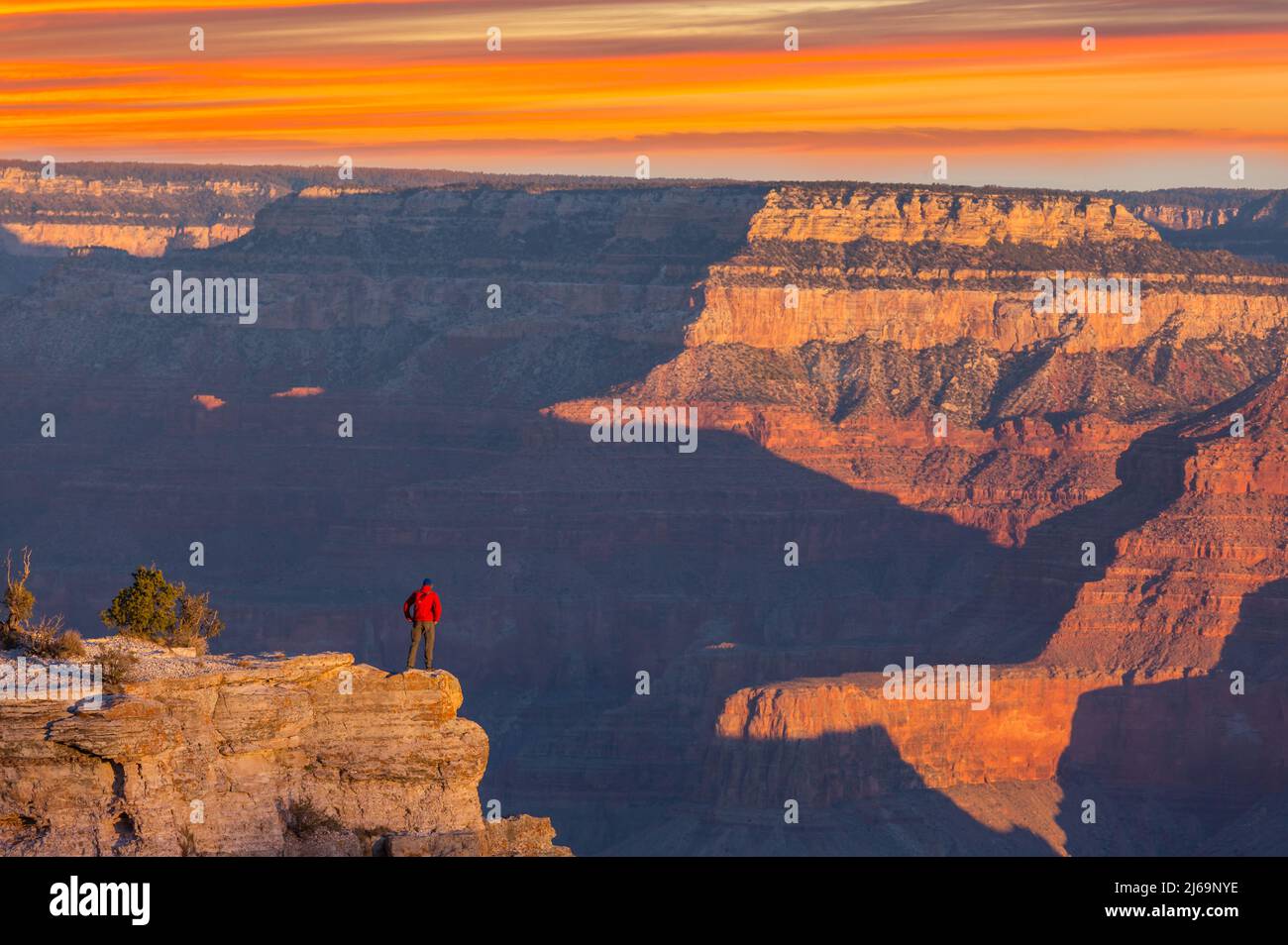 Traveler on cliff mountains over Grand Canyon National Park, Arizona ...