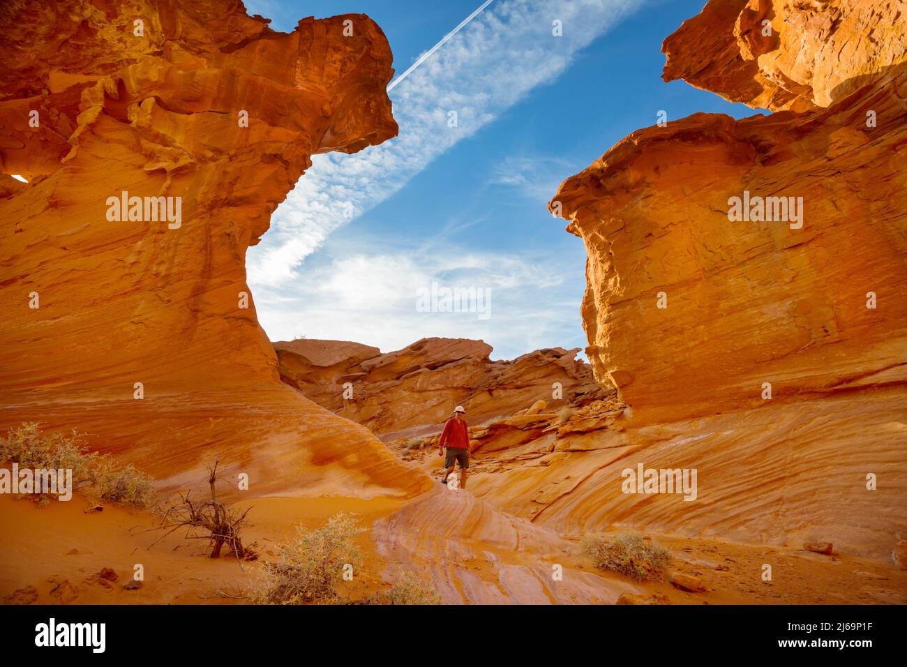 Hiker inside a stone arch in the Nevada desert near Las Vegas, Nevada ...