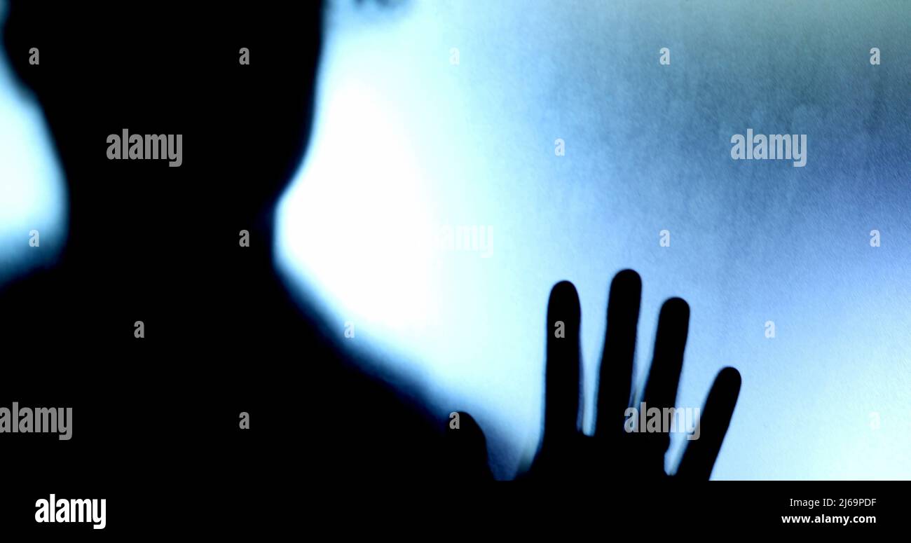 Woman behind diffused glass feeling trapped. Mental illness concept ...