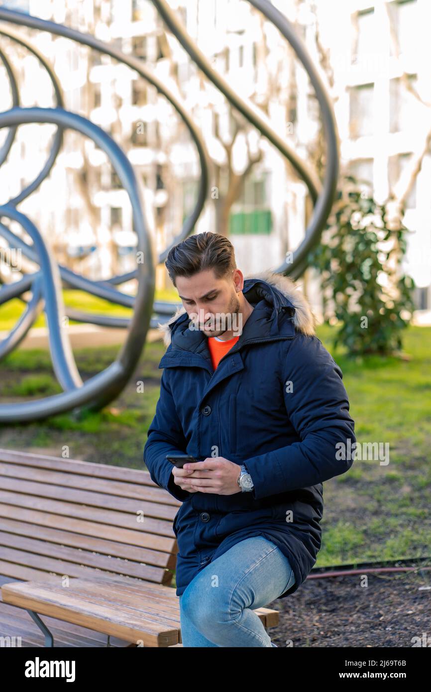 attractive young man using his smartphone Stock Photo - Alamy