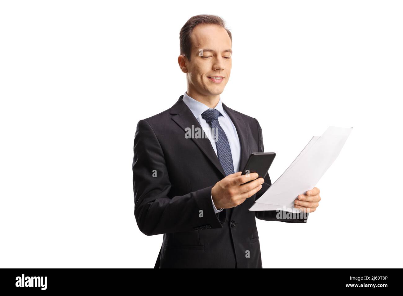Businessman using a mobile phone and holding a paper document isolated ...