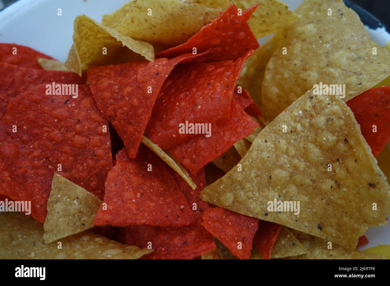 Orange and yellow nacho chips as a close up Stock Photo - Alamy
