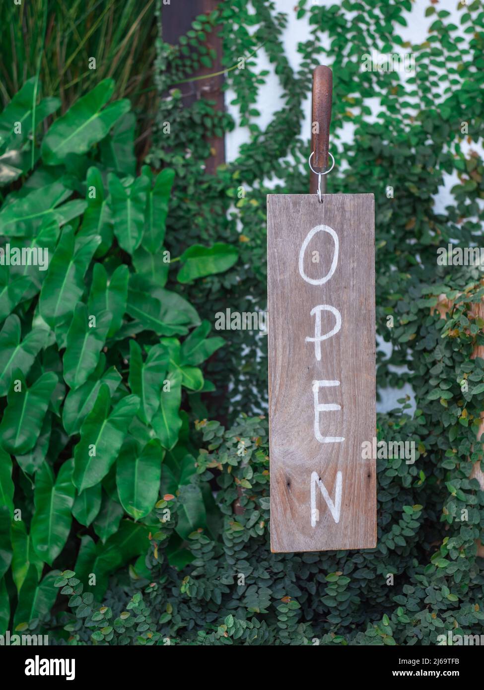 Open signboard hanging in the garden Stock Photo - Alamy