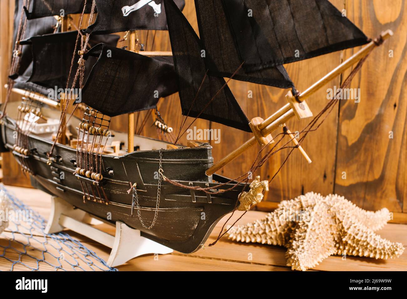 Model of old pirate ship on wooden background Stock Photo - Alamy
