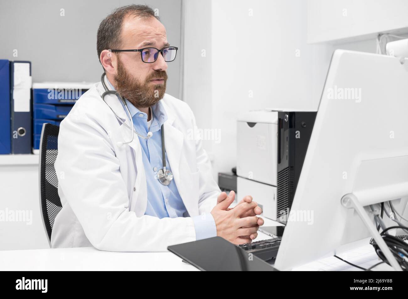 Doctor talking to online patient on desktop computer screen sitting at ...