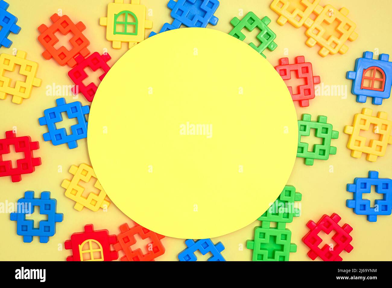 Decorative yellow round kids template frame on colourful plastic kids ...