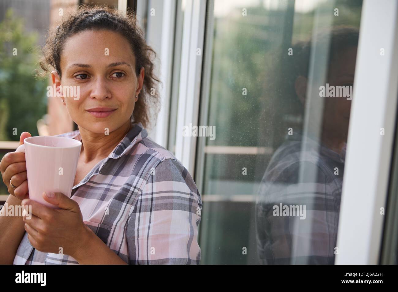 Attractive Hispanic middle-aged woman thoughtfully looking aside ...