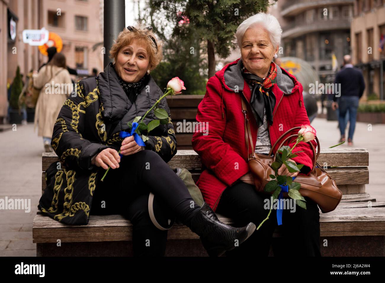 Views of Yerevan. Genre photography. Elderly women rest on a bench on ...