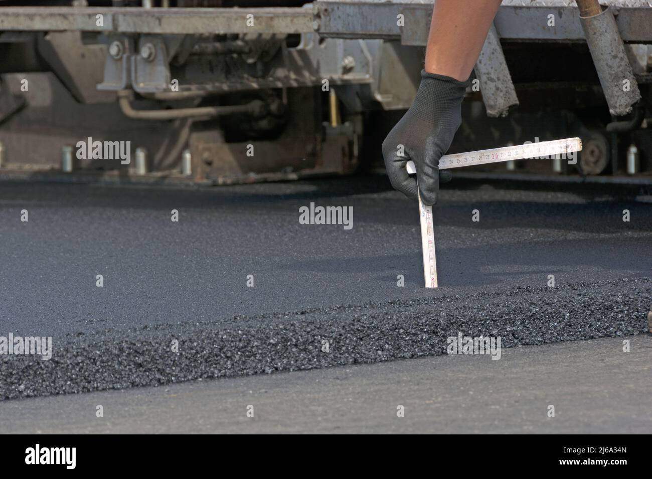 Checking the asphalt surface course Stock Photo - Alamy
