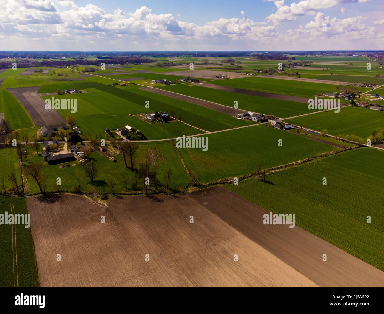 Spring fields, meadows and villages seen from a bird's eye view on a ...