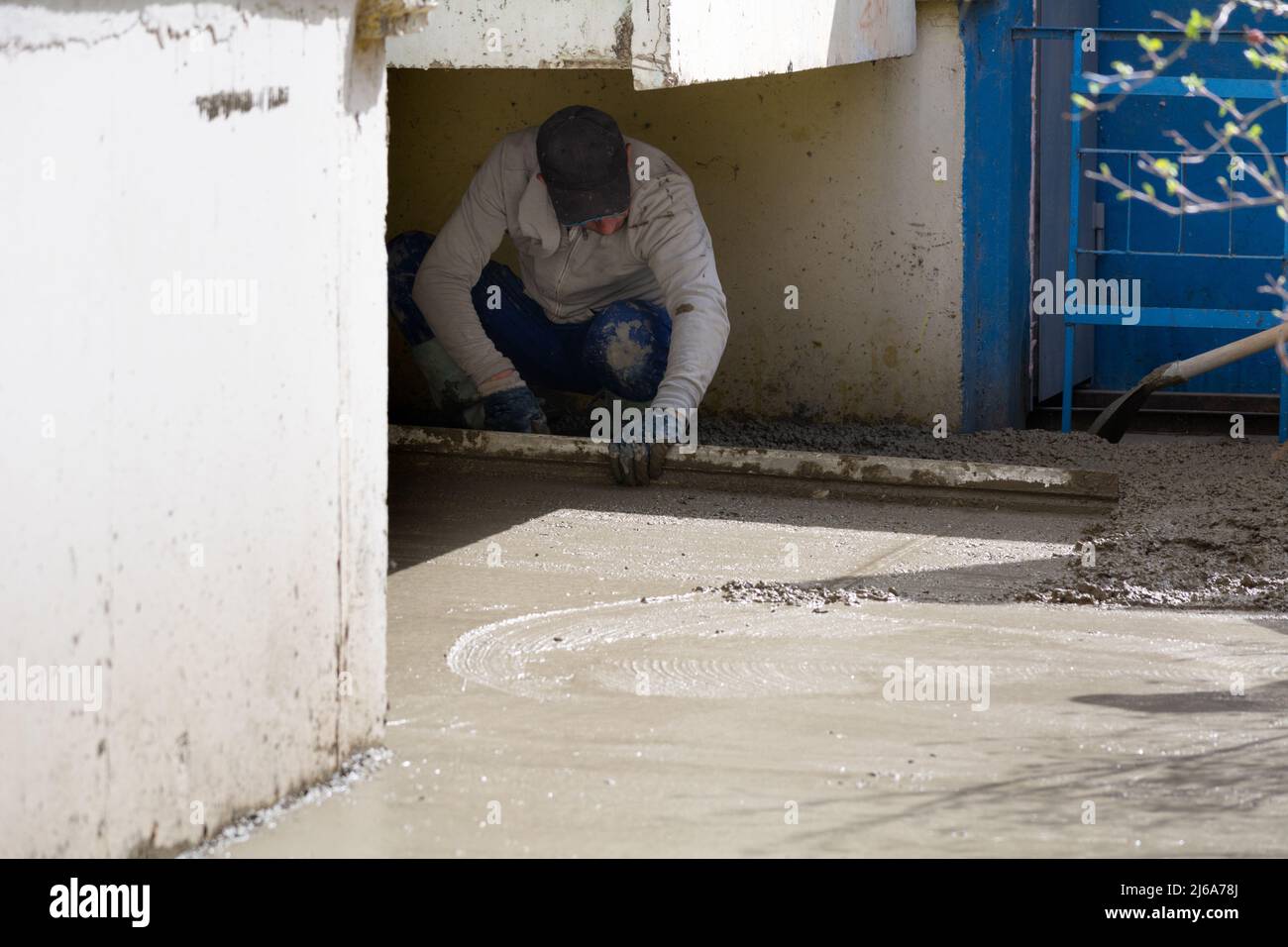 Construction workers aligns concrete screed. Construction, Foundation ...