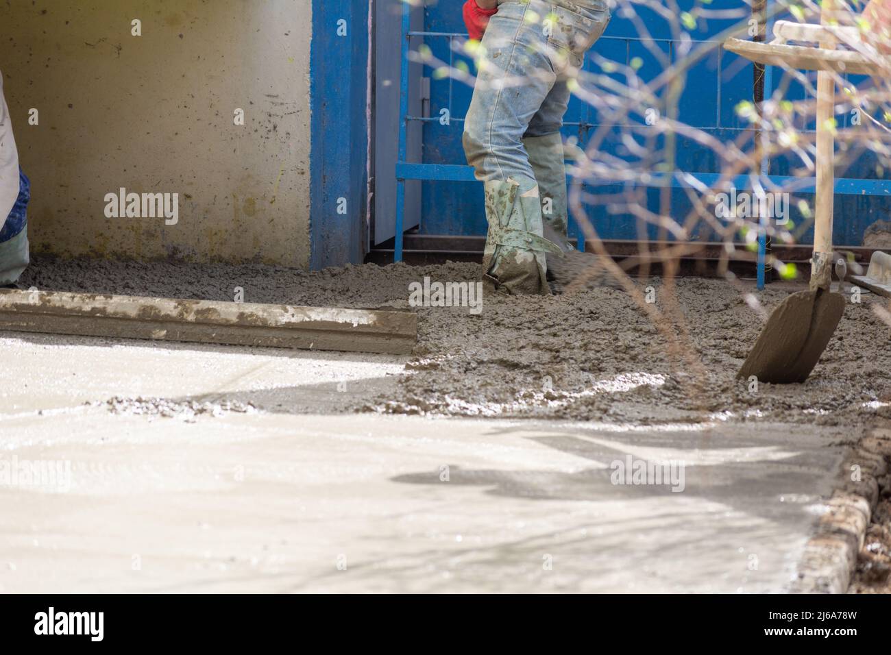 Construction workers aligns concrete screed. Construction, Foundation ...