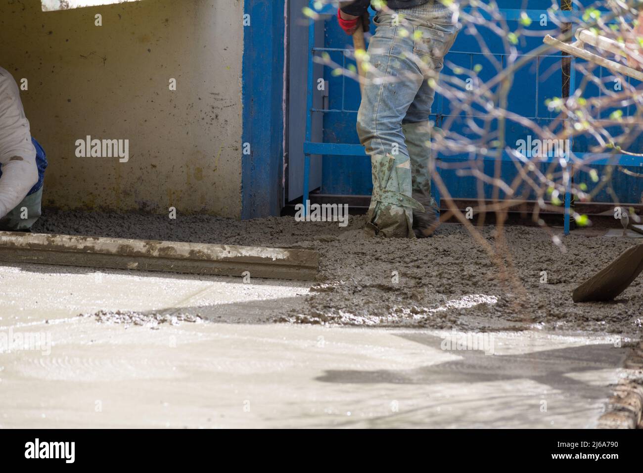 Construction workers aligns concrete screed. Construction, Foundation ...