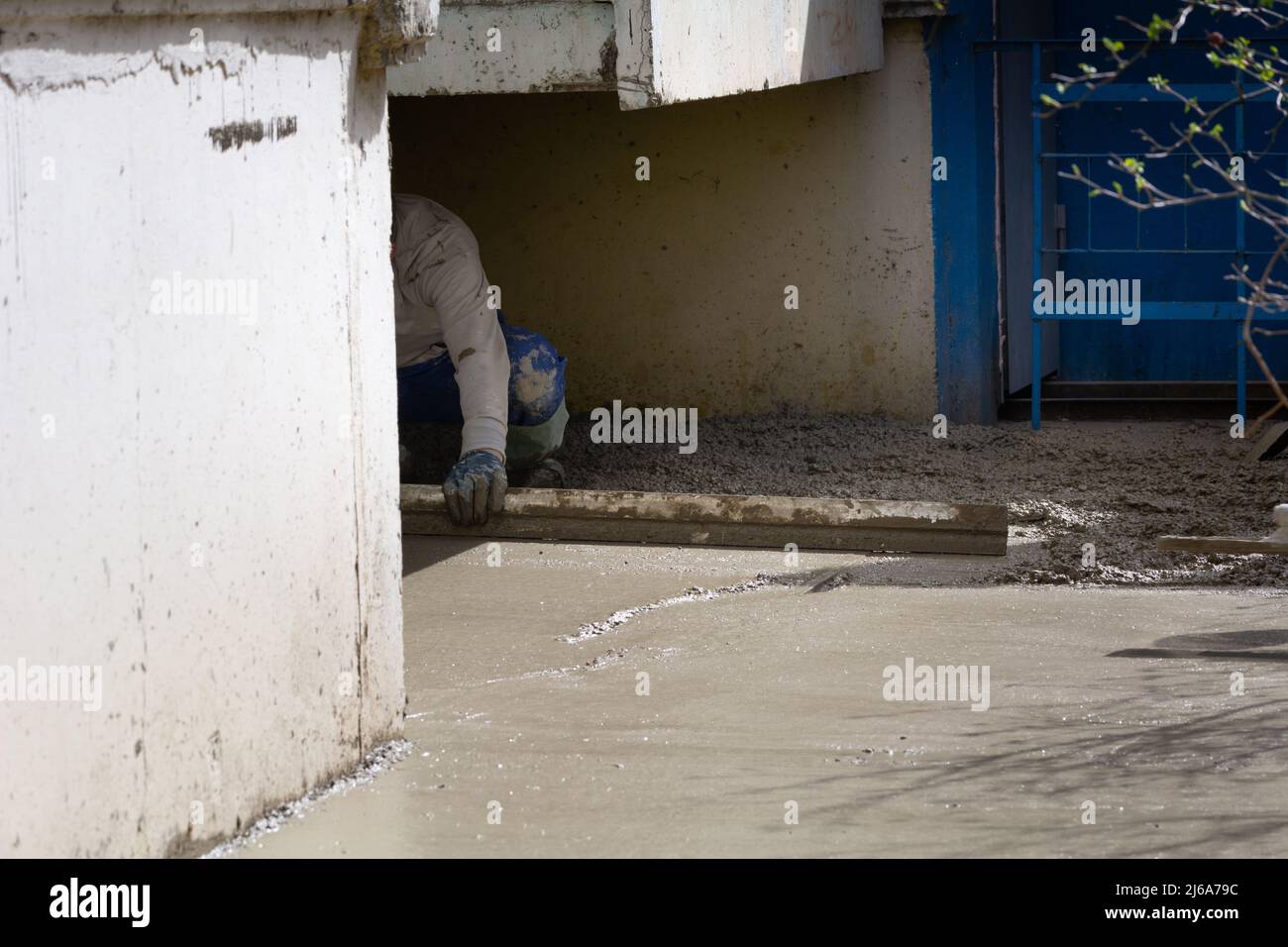 Construction workers aligns concrete screed. Construction, Foundation ...