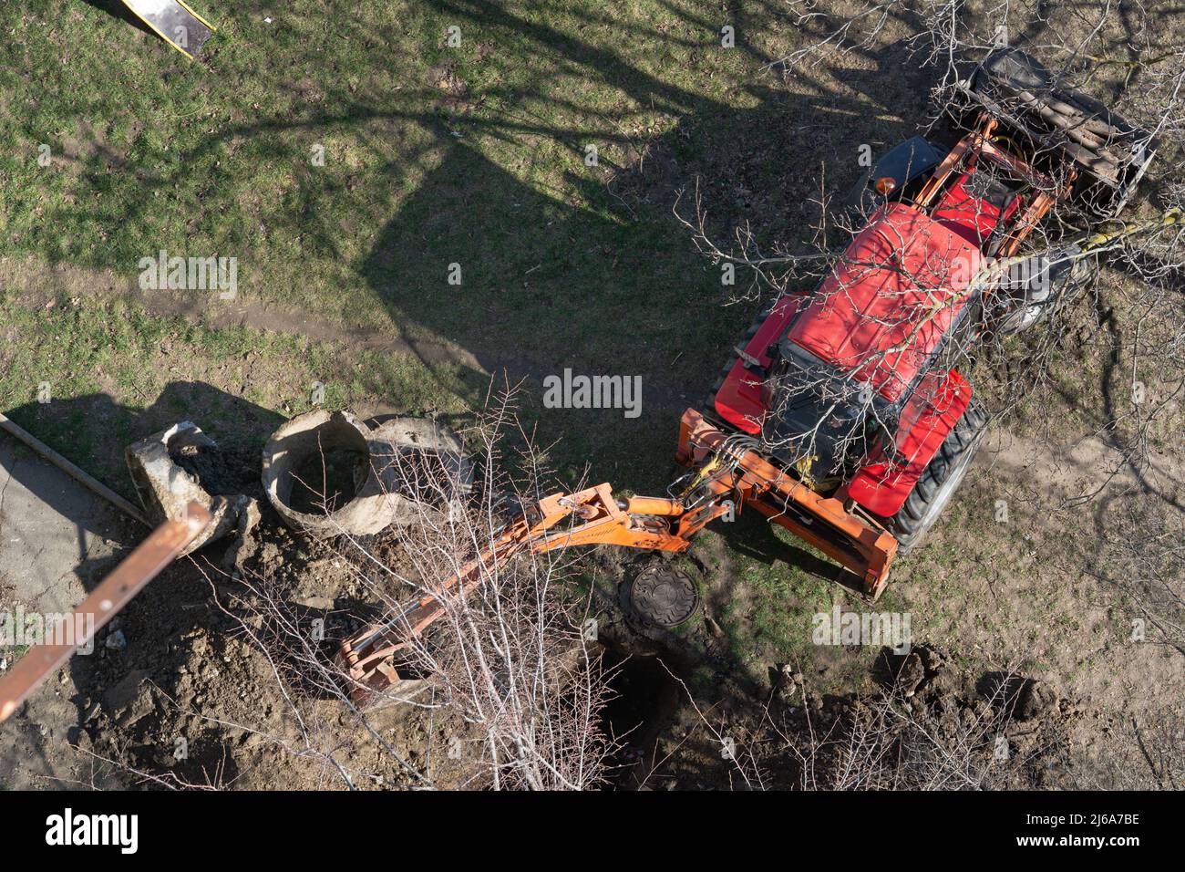 Excavator Tractor digs a hole, top view. The tractor is digging a hole ...