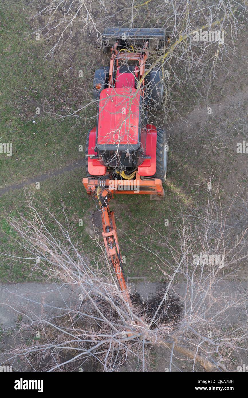 Excavator Tractor digs a hole, top view. The tractor is digging a hole ...